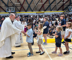 Students surprise Archbishop-elect Thomas Zinkula - The Catholic Messenger